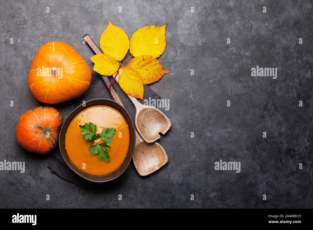 Pumpkin vegetable soup on stone backdrop. Top view with copy space ...