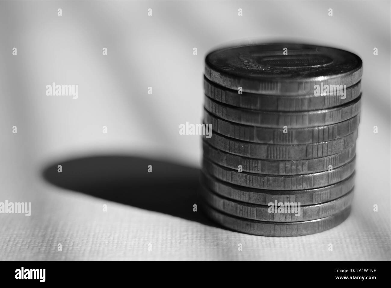 Tower of coins. Hard sunlight and shadows. Side view. Bw photo Stock ...