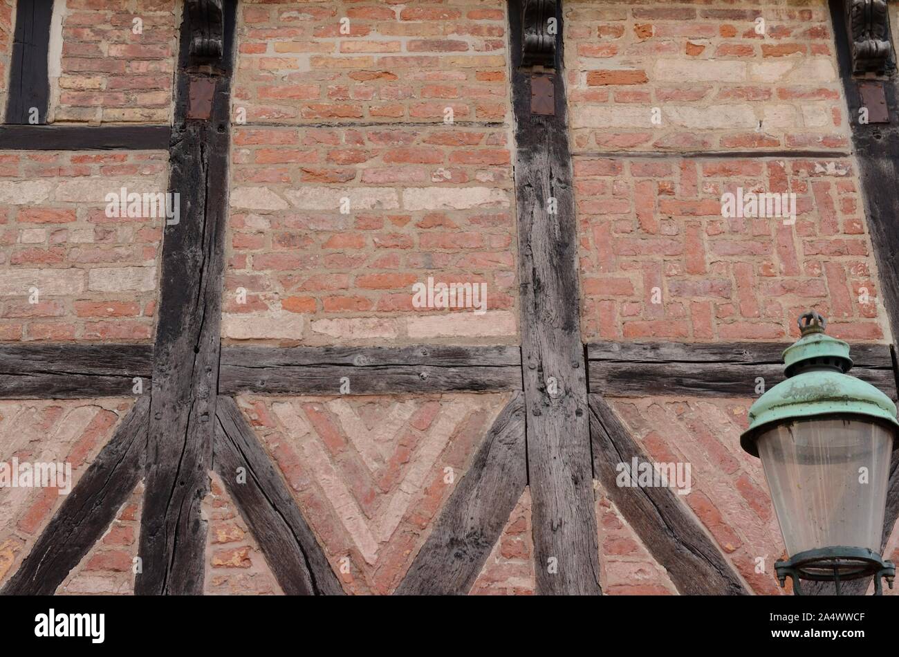 Street lamp and brick wall with wood in the old town of Malmo, Sweden ...