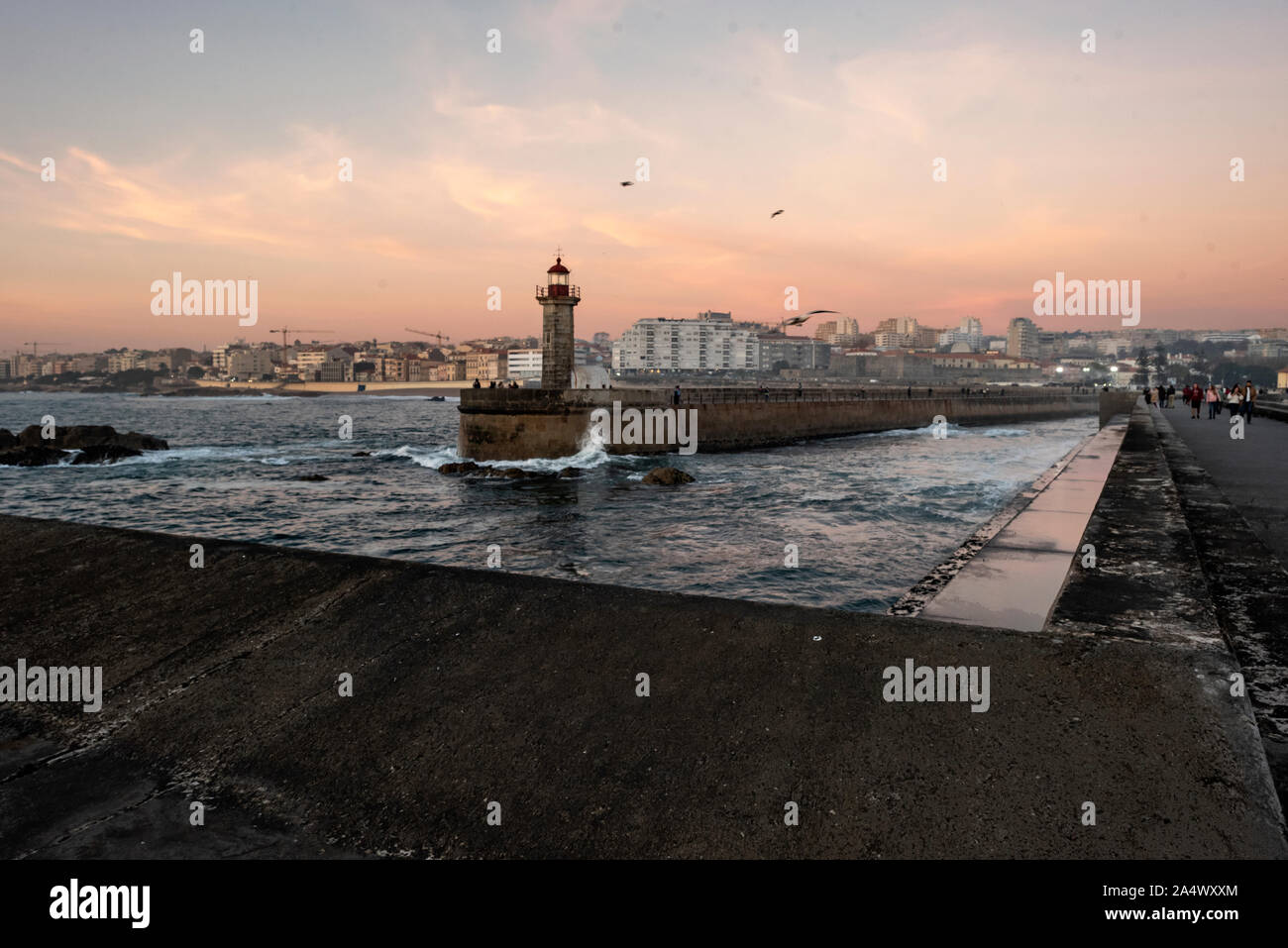 Sunset at lighthouse in the Douro river mouth Stock Photo - Alamy