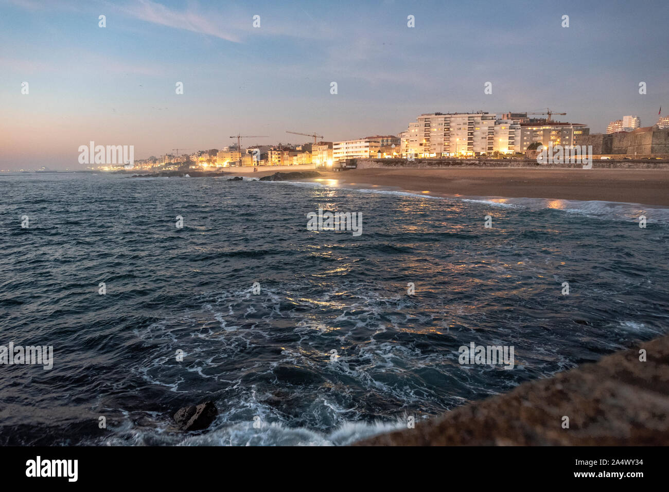 Sunset at lighthouse in the Douro river mouth Stock Photo - Alamy