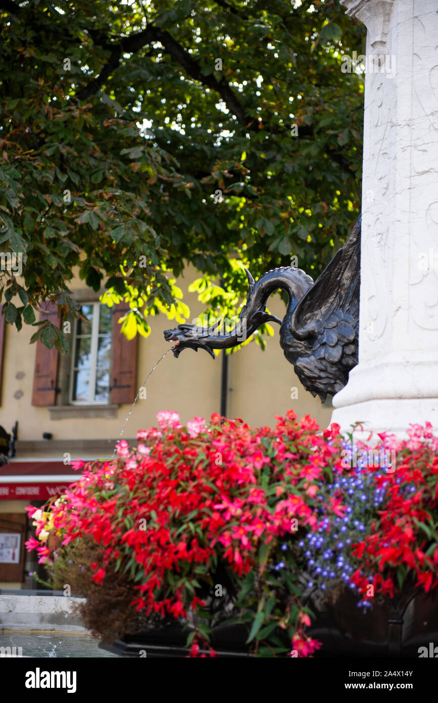 Waterfountain with cast iron spout and colorful flowers, Geneva Stock ...