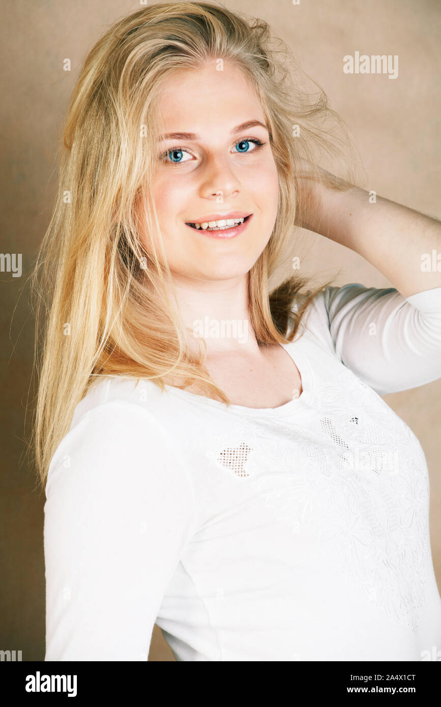 young cool blong teenage girl messed with her hair smiling Stock Photo ...