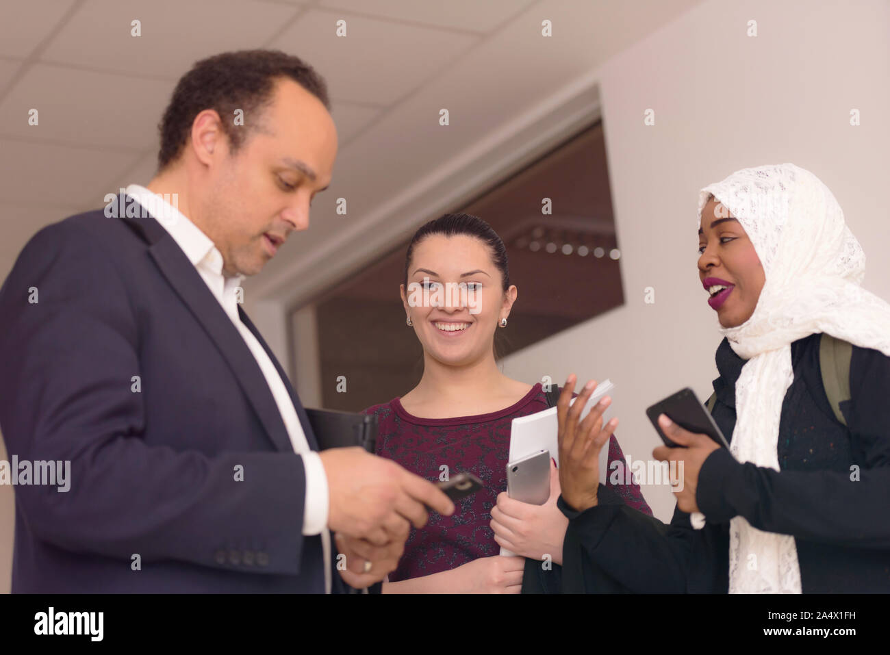Professor talking to students in office hi-res stock photography and ...