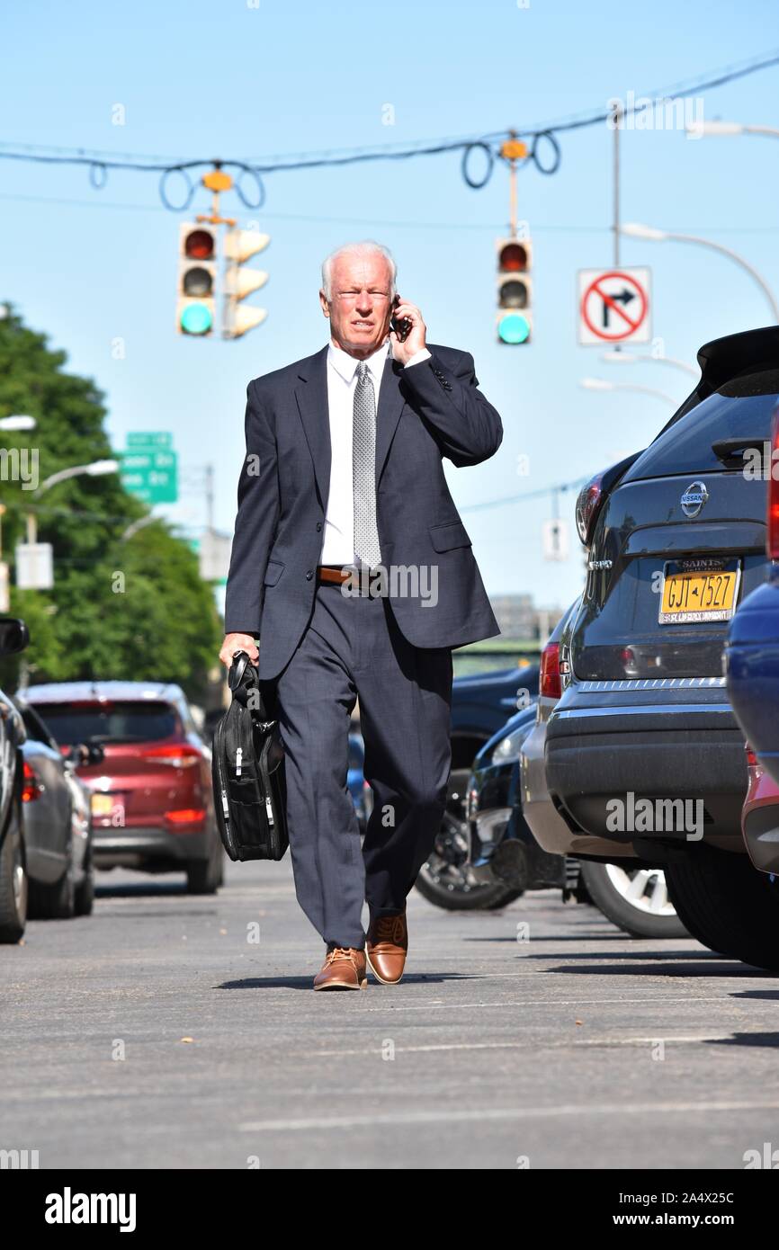 Serious Business Man Walking Stock Photo - Alamy