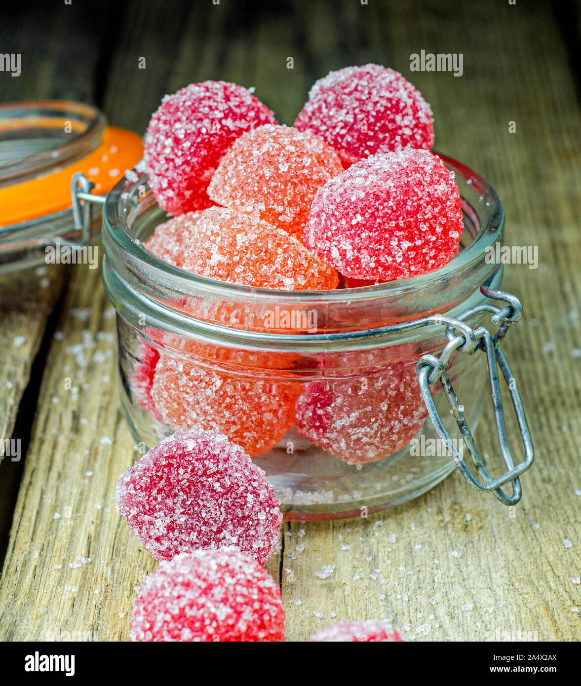 Assorted colorful candies fallen out of jar Stock Photo - Alamy