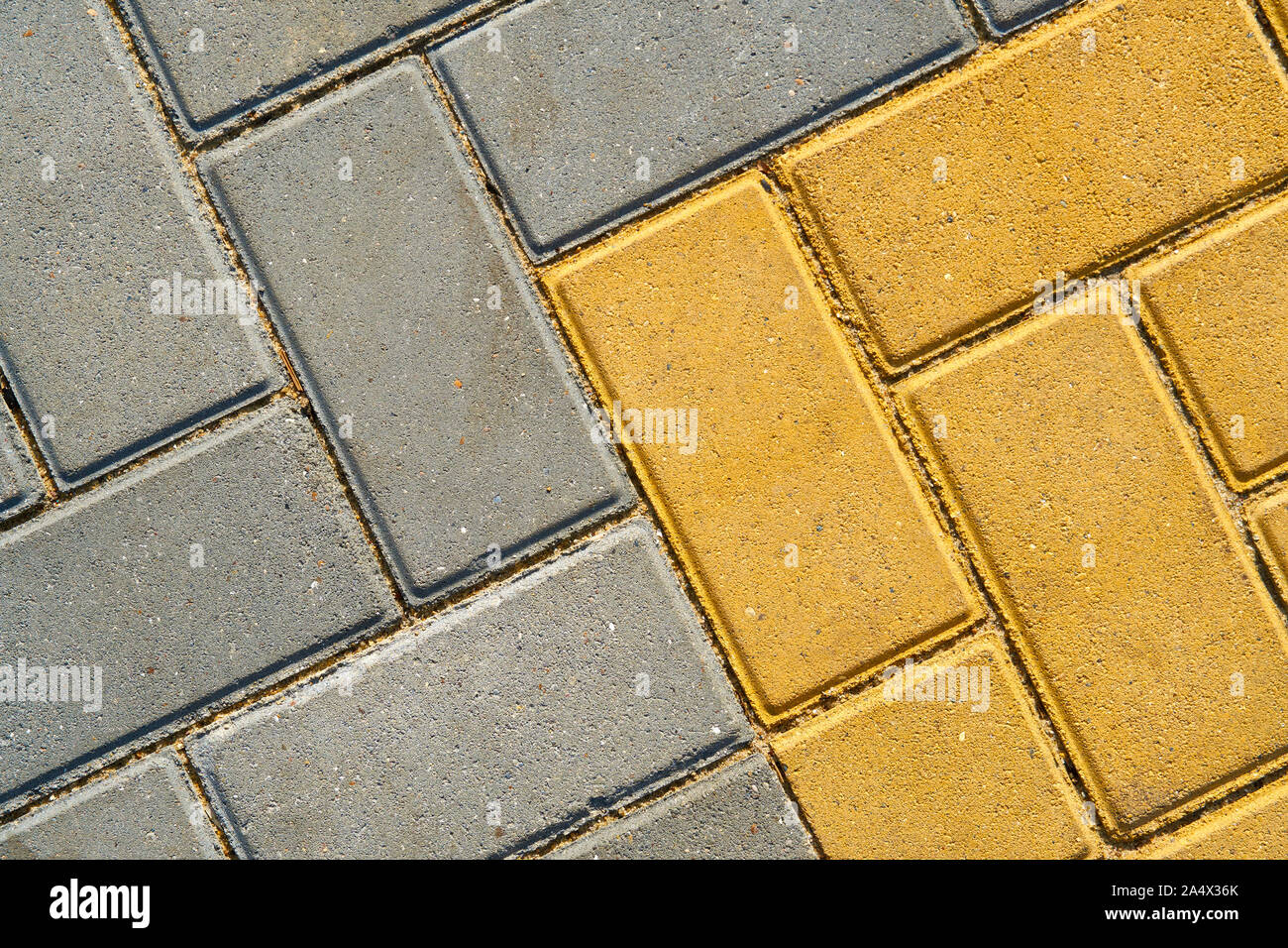 yellow and grey paving tile for background or texture Stock Photo - Alamy