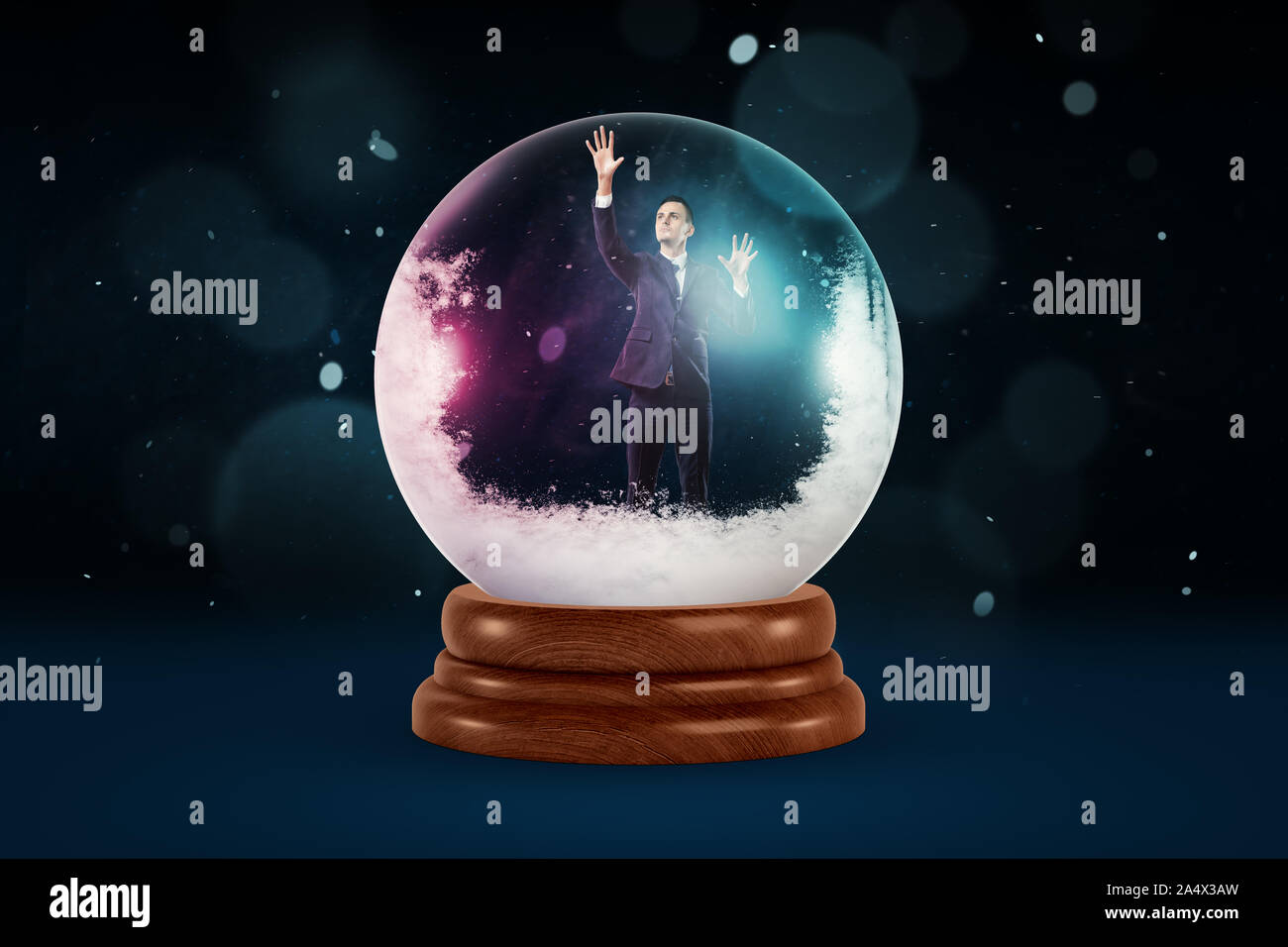 A tiny businessman inside a snowy crystal ball on a dark background ...
