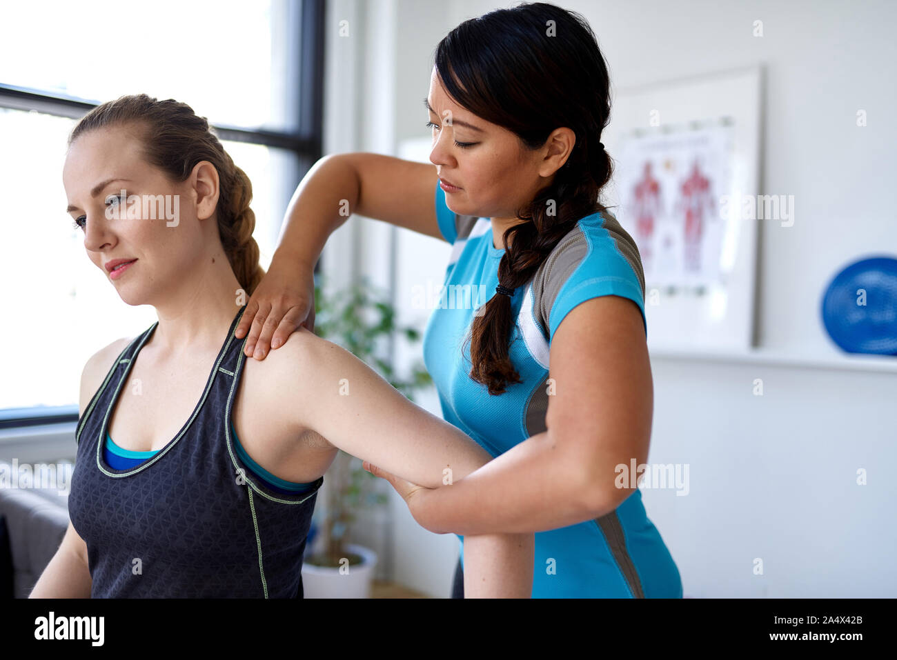 Chinese woman physiotherapy professional giving a treatment to a Stock ...