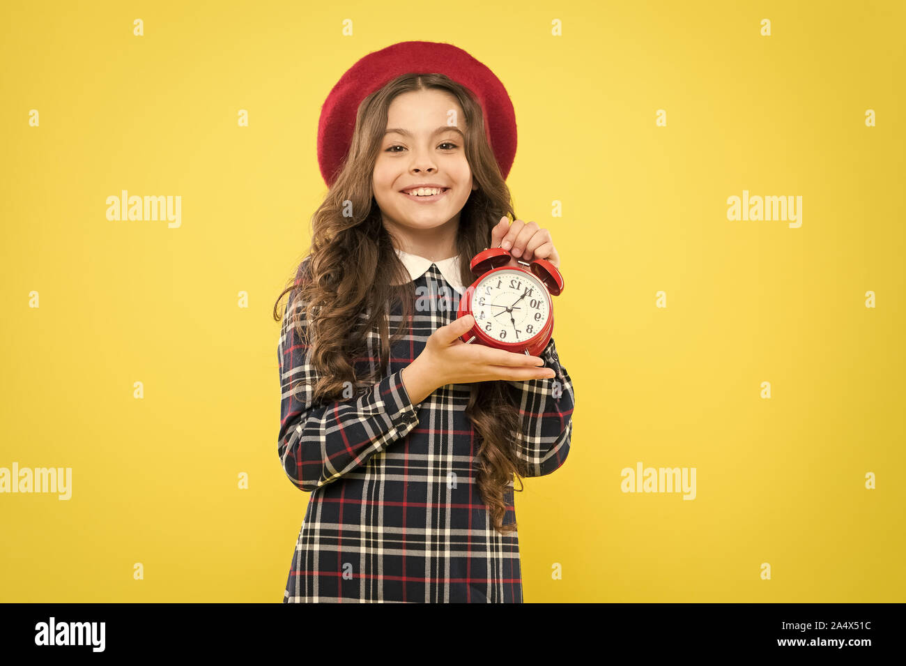 Timing is everything. Happy small child showing proper timing on yellow ...