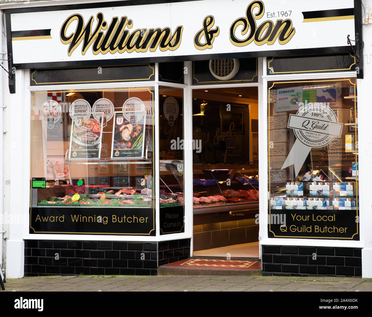 Two Spaniels wait for their owner outside Williams & Son butchers shop ...