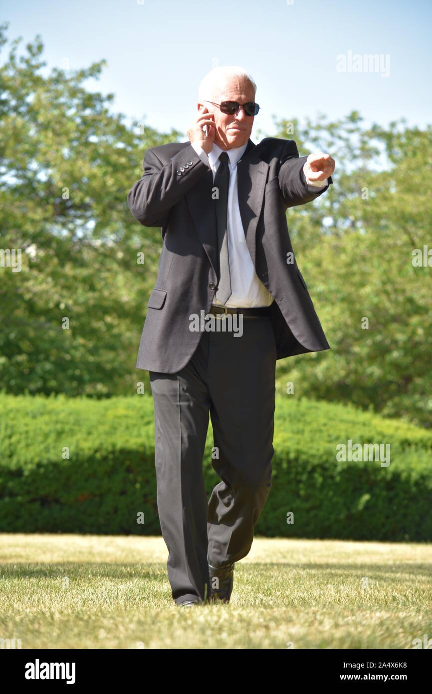 Senior Security Guard Pointing Wearing Sunglasses Walking Stock Photo ...