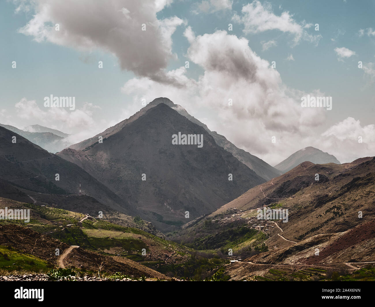 A mountain with double peaks looks like volcano evaporating clouds from ...