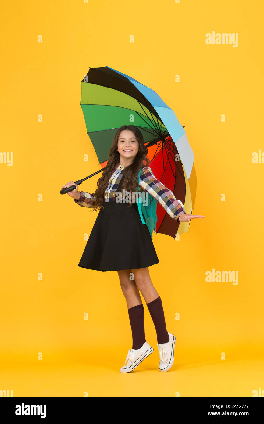 Schoolgirl daily life. Girl with umbrella. Rainy day. Happy childhood. Kid happy schoolgirl with ...