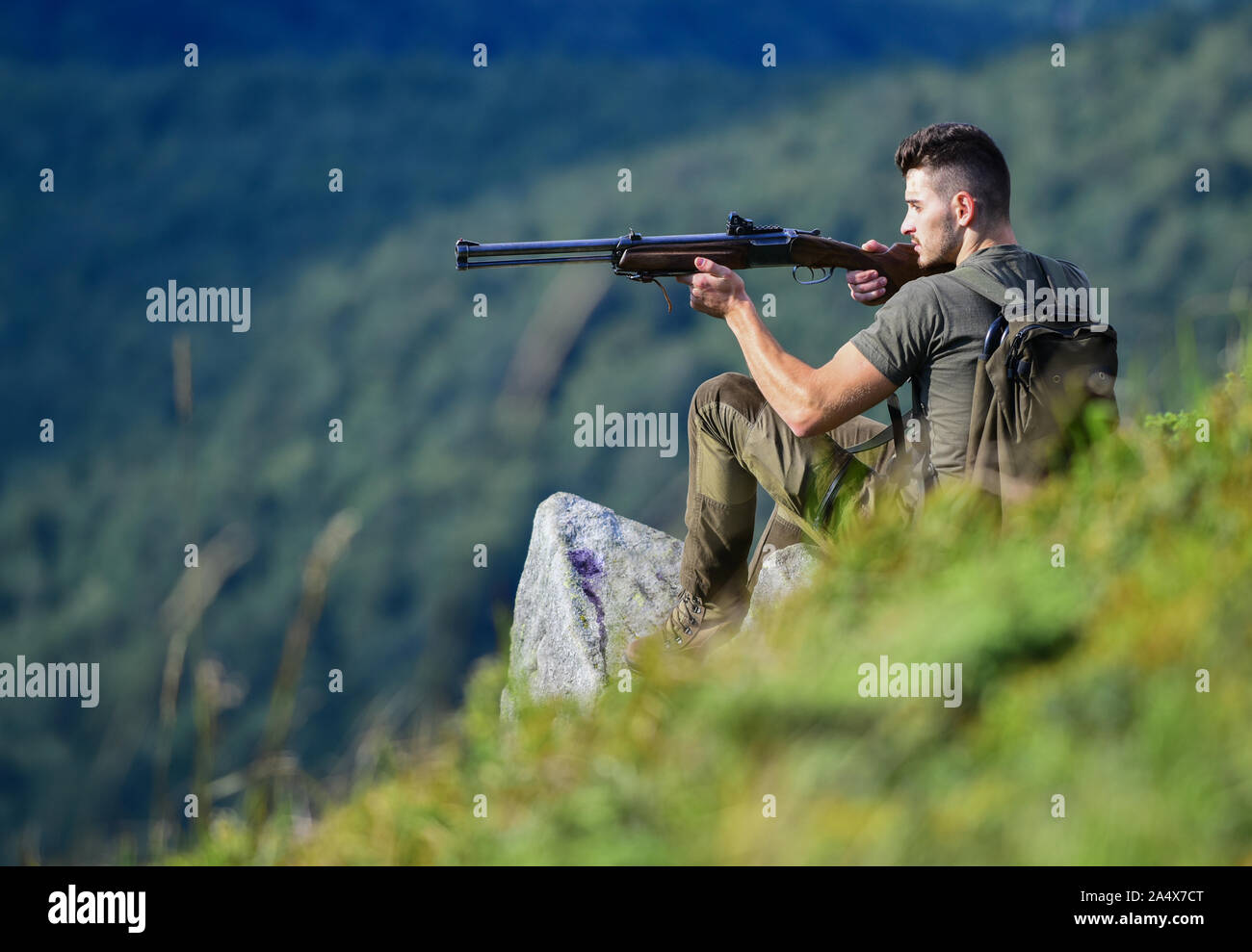 soldier in the field. combat readiness. muscular man hold weapon ...