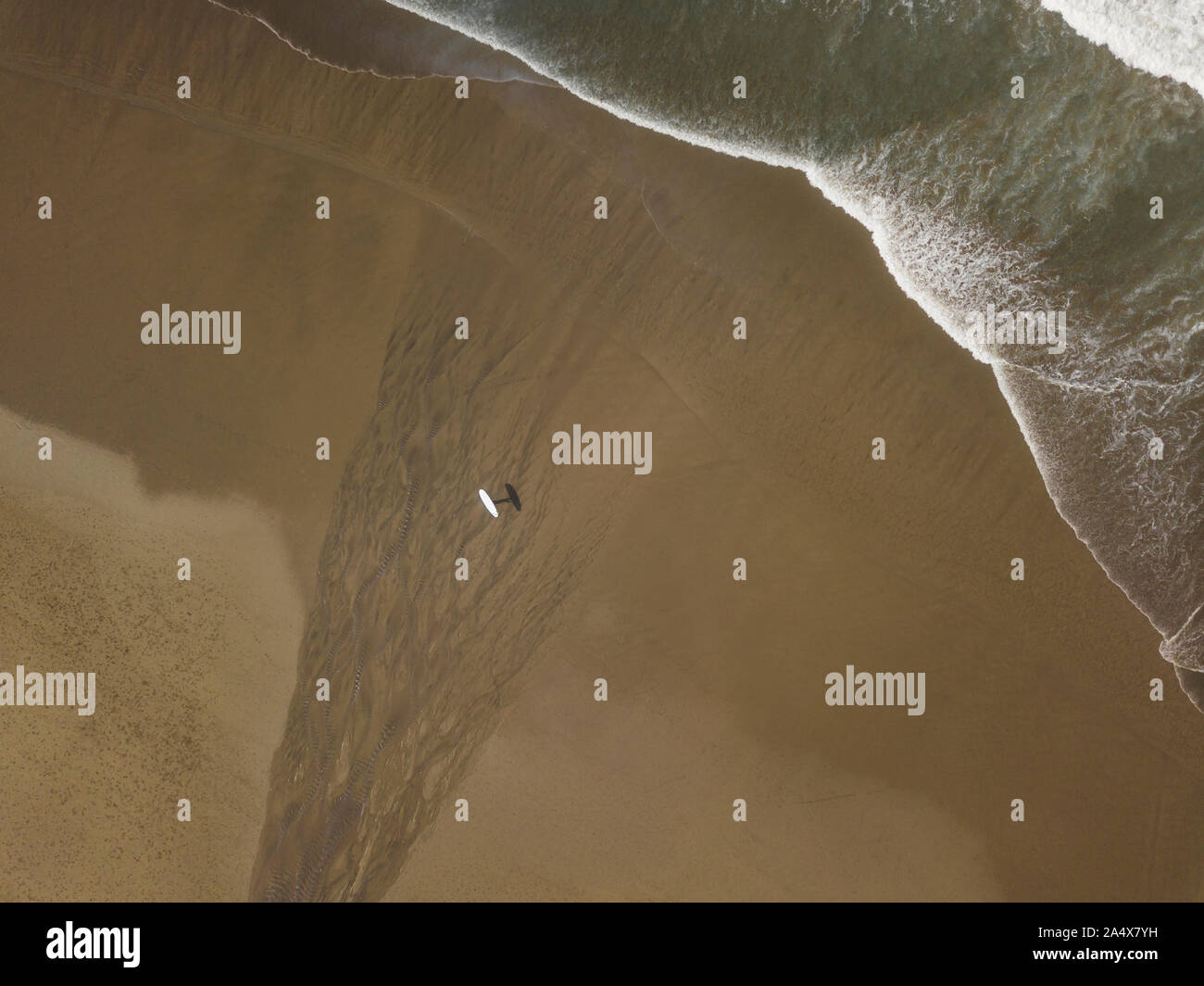 Aerial view of surfer at the beach Stock Photo - Alamy