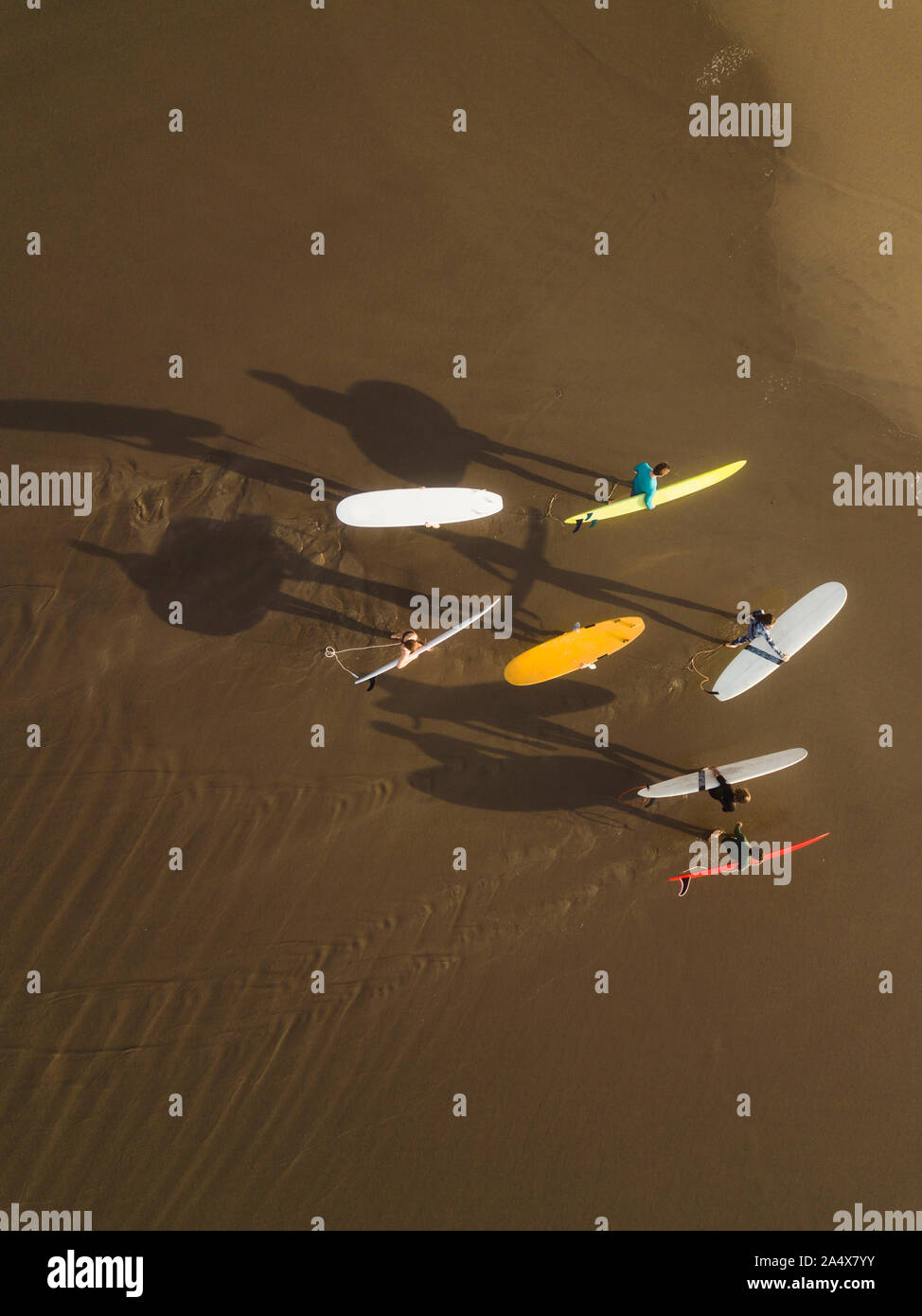 Aerial view of surfers at the beach Stock Photo - Alamy
