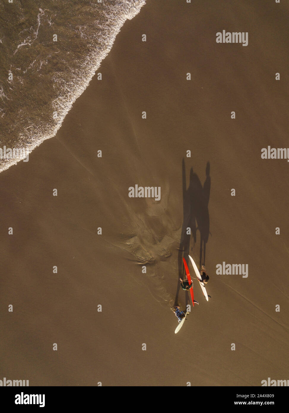 Aerial view of surfers at the beach Stock Photo - Alamy
