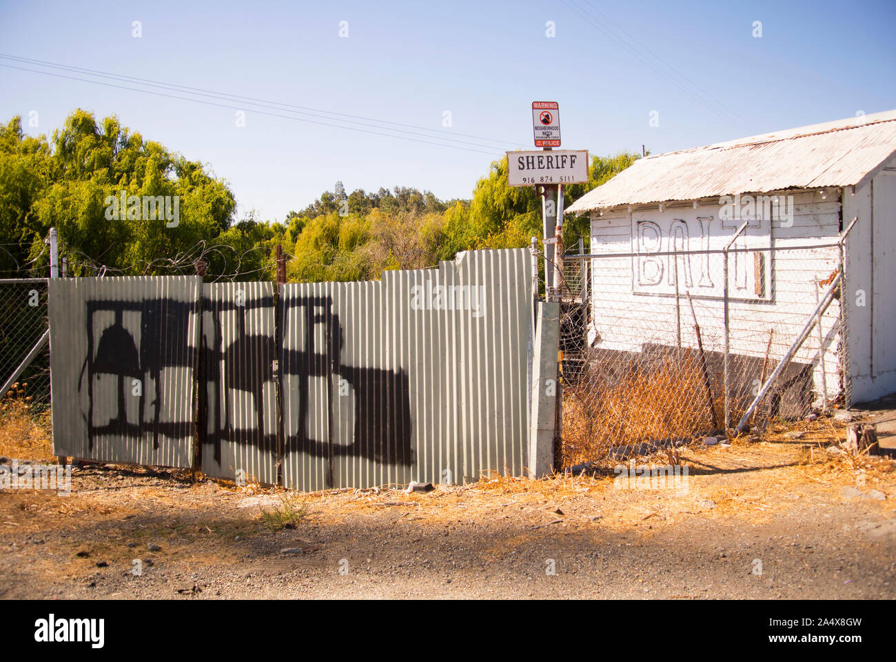 Unreadable graffiti sheriff sign next to vacant bait shop hi-res stock ...