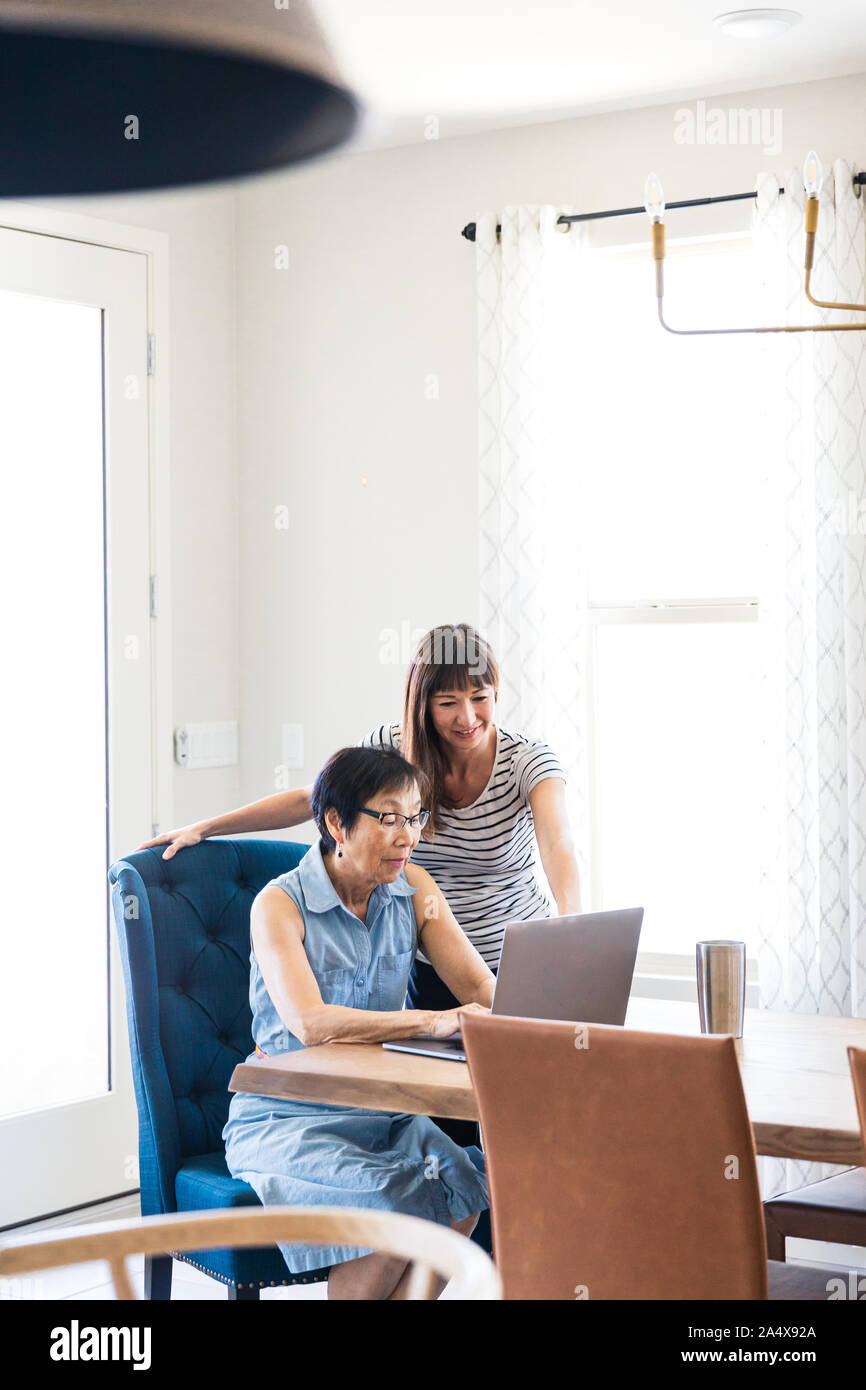Daughter Helping Mother With Computer Stock Photo - Alamy