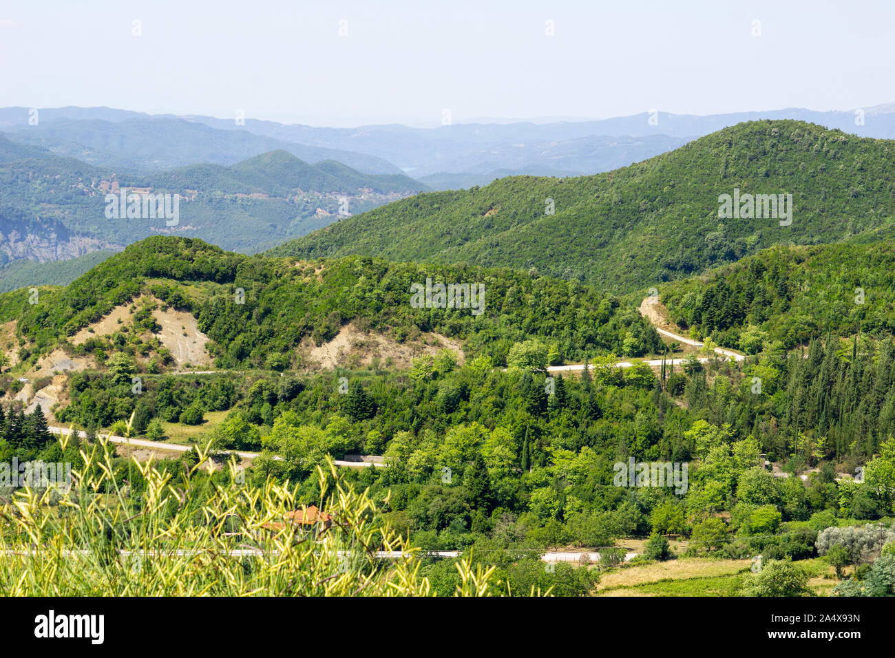 Winding road through expansive views traveling through Greece's rugged ...