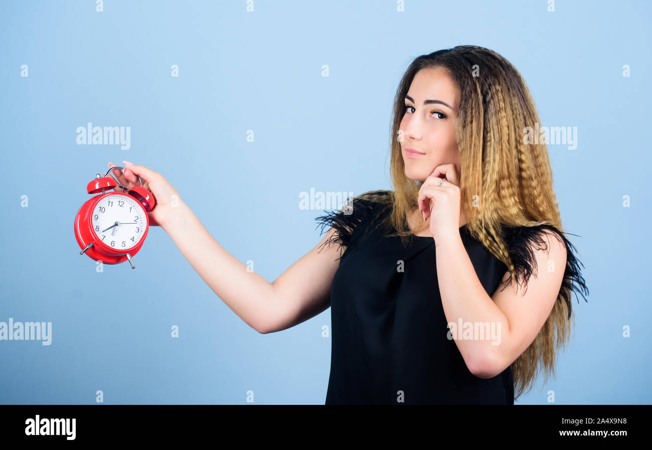 Woman hold red alarm clock. Counting time till deadline. Pretty girl ...