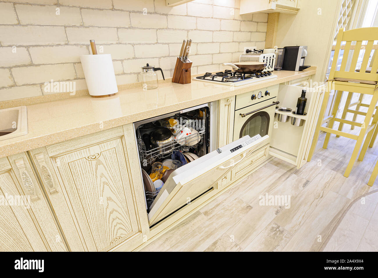Luxury modern beige kitchen closeup, some drawers open Stock Photo - Alamy