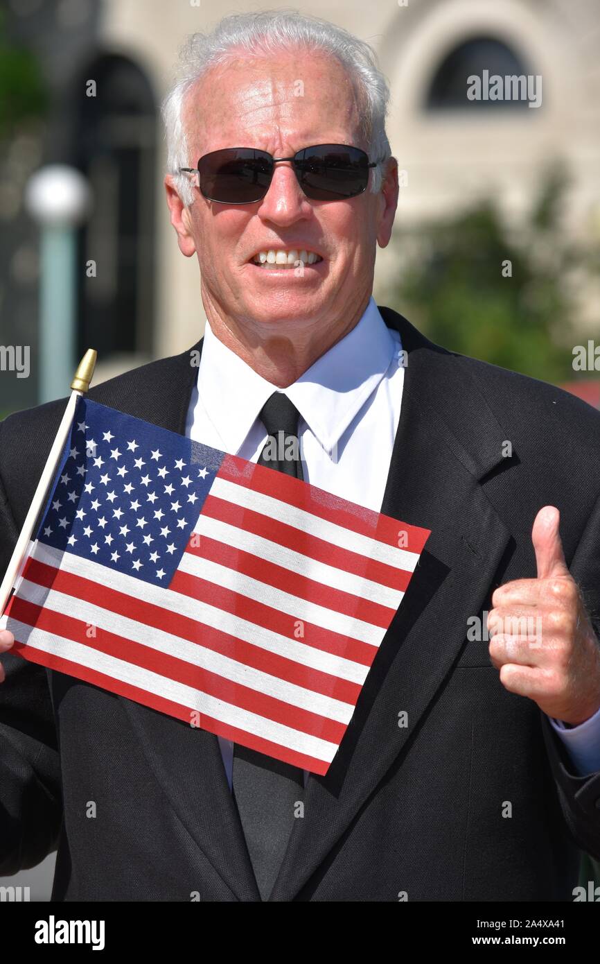Male Politician With Thumbs Up Wearing Business Suit Stock Photo - Alamy