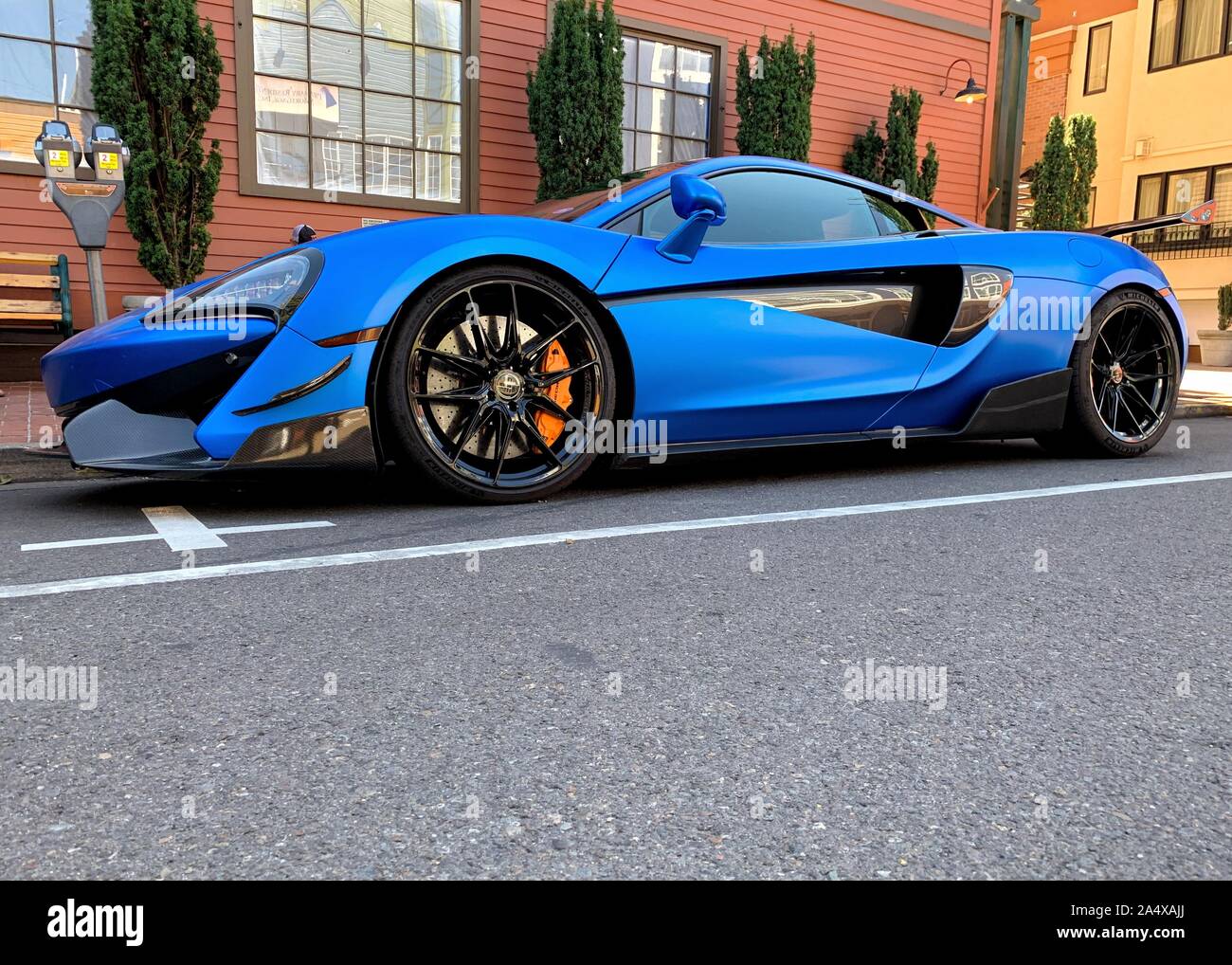 A blue McLaren super car parked on a city street Stock Photo - Alamy