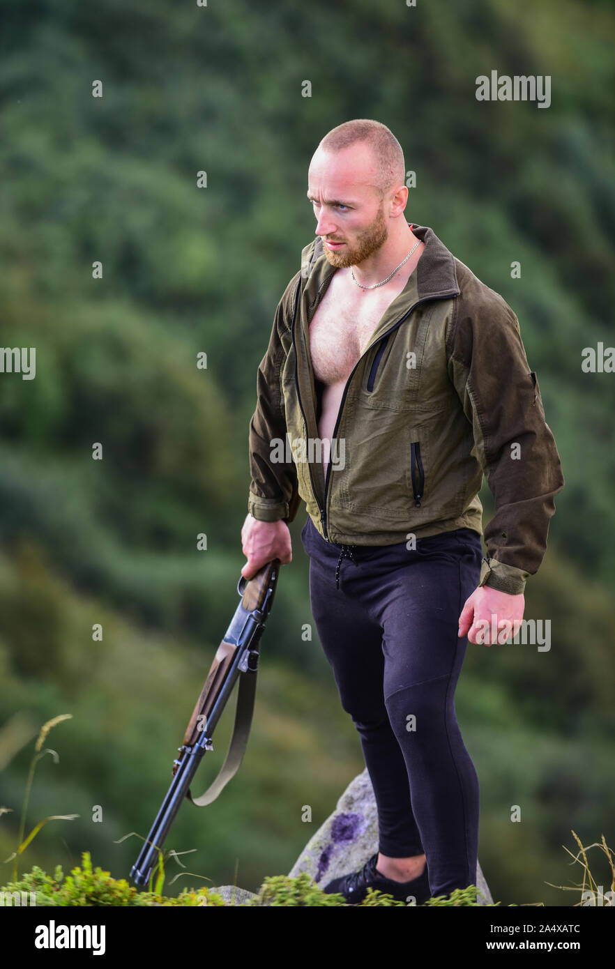 Poaching concept. Poacher stand on edge of cliff. Hunter poacher ...