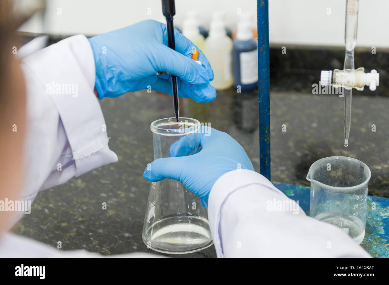 Woman hands performing titration test on chemical quality control Stock ...