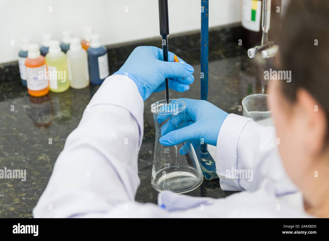 Woman hands performing titration test on chemical quality control Stock ...