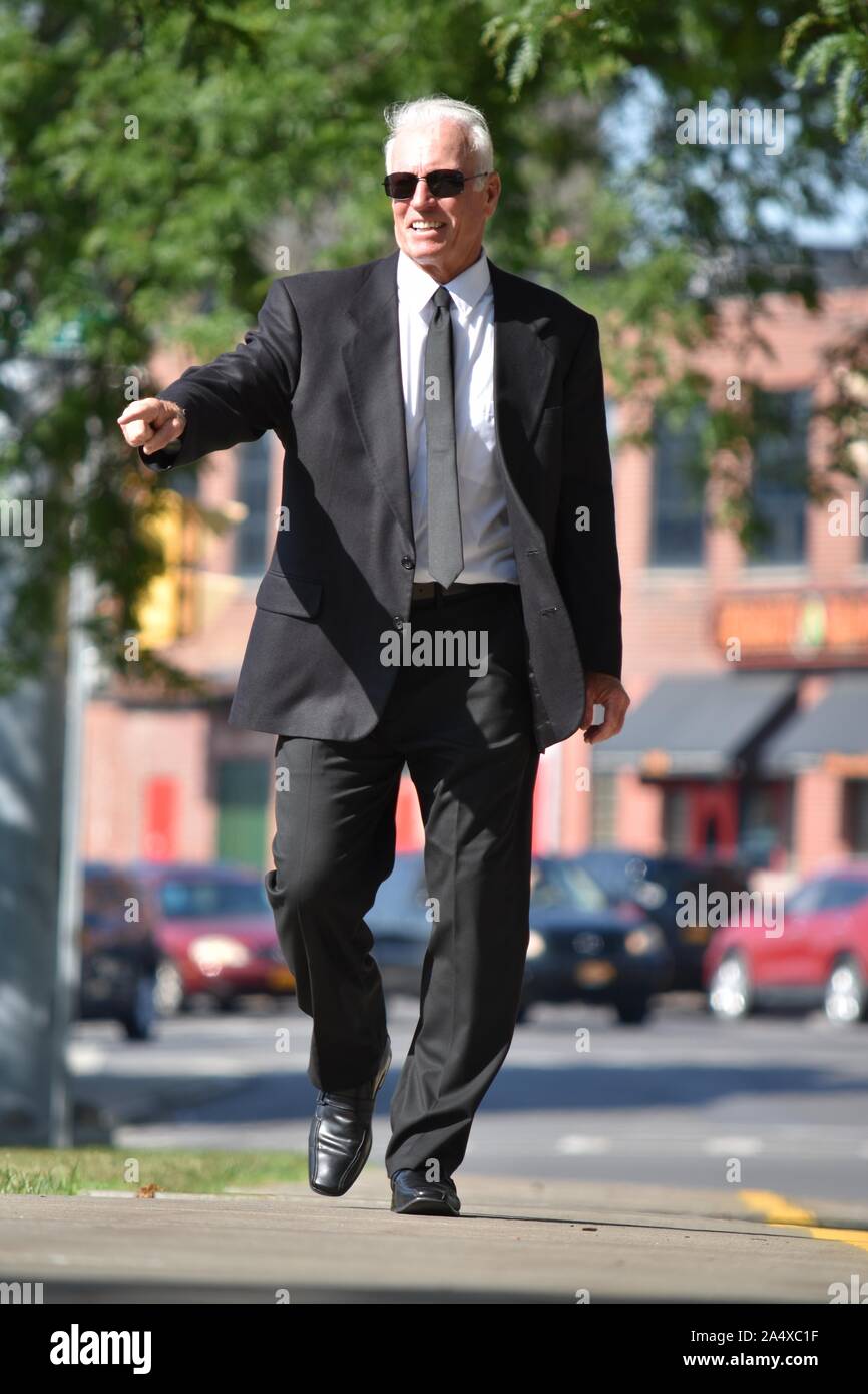 Male Politician Pointing Walking On Sidewalk Stock Photo - Alamy