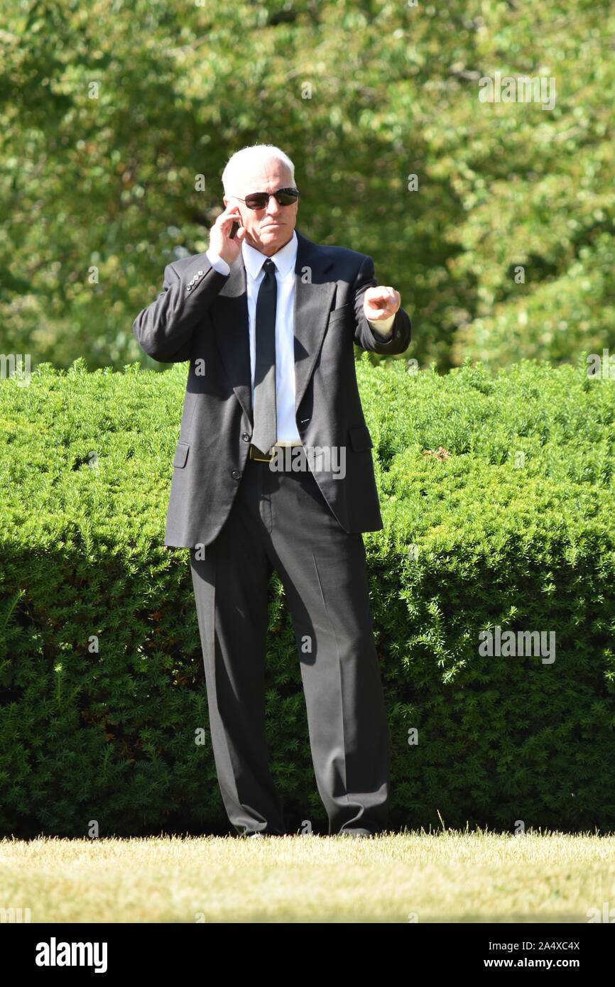 Handsome Senior Security Guard Pointing Walking Stock Photo - Alamy