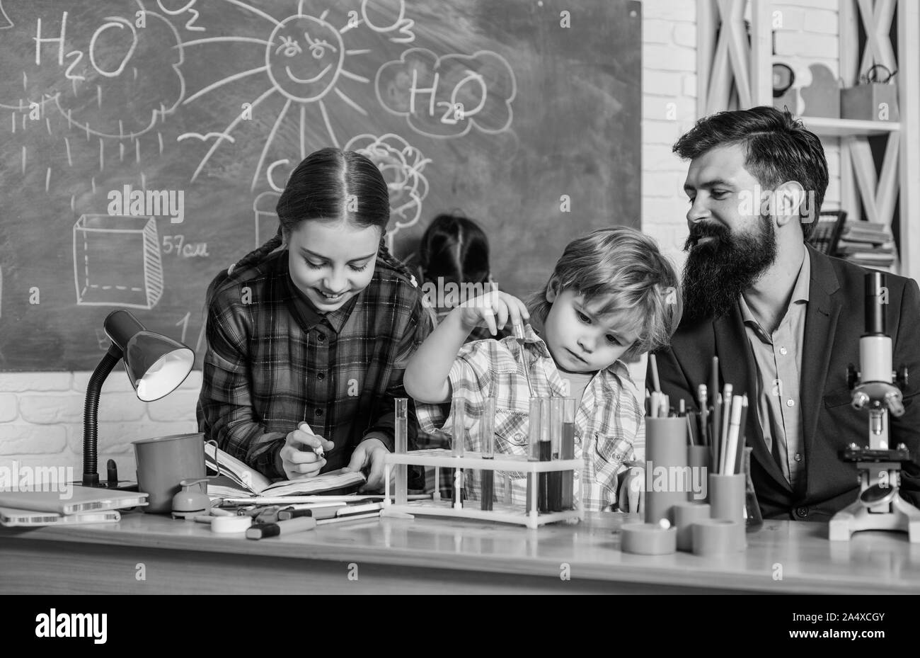 Pupil looking through microscope at the elementary school ...