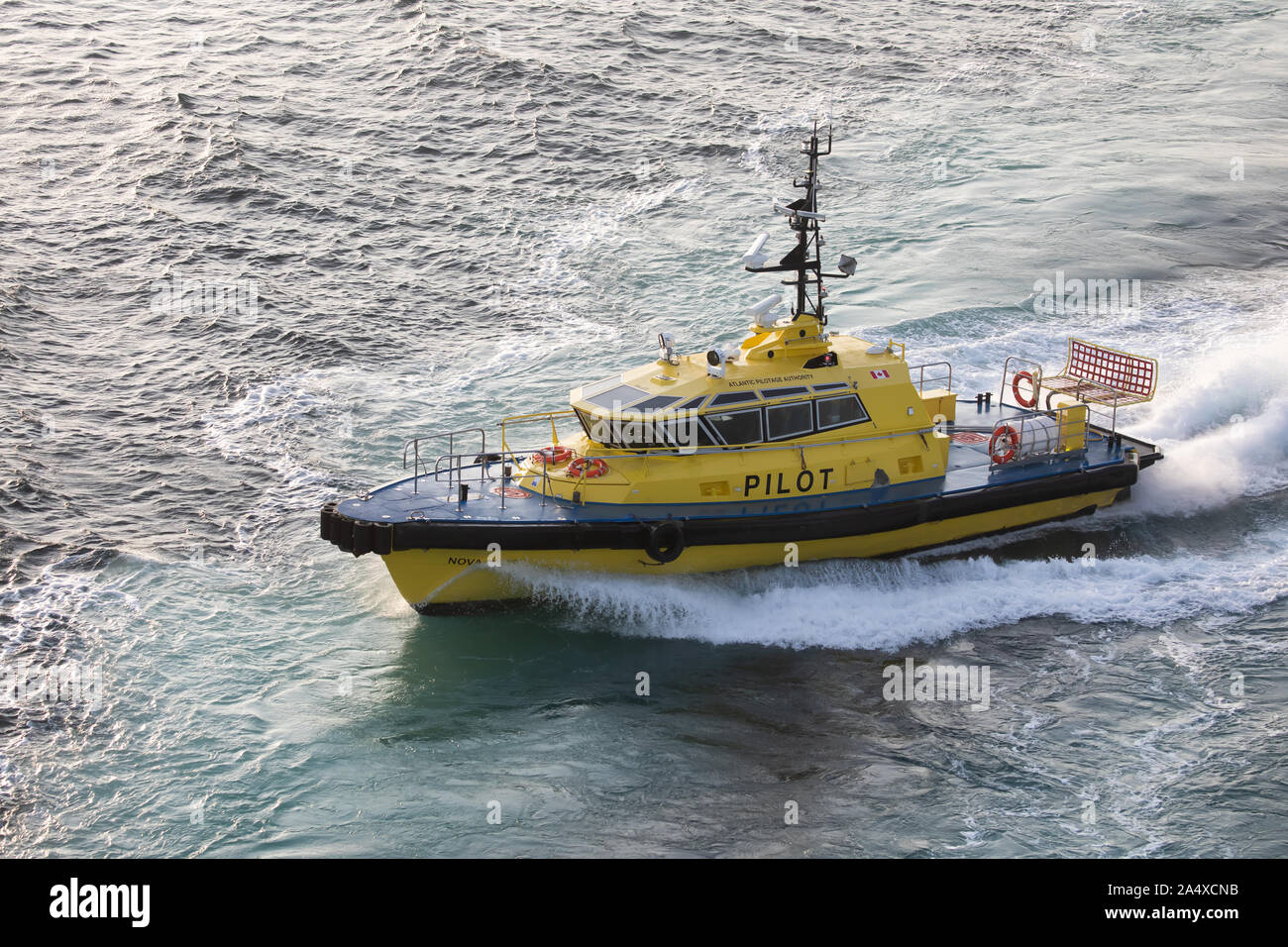 Blue and yellow coloured Pilot Boat on the Atlantic Ocean near Halifax ...