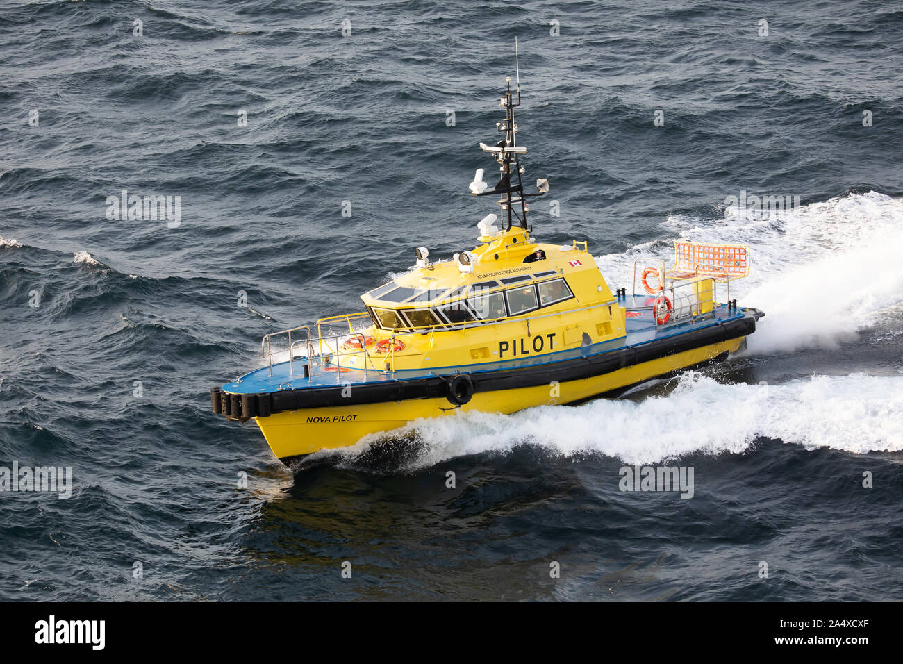 Blue and yellow coloured Pilot Boat on the Atlantic Ocean near Halifax ...