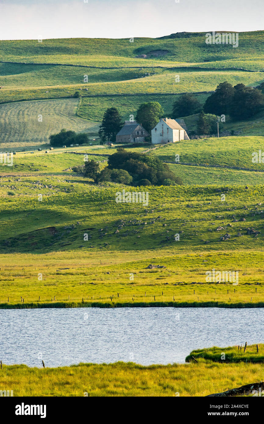 Farm, lake and meadows: a landscape of the Aubrac plateau in France ...