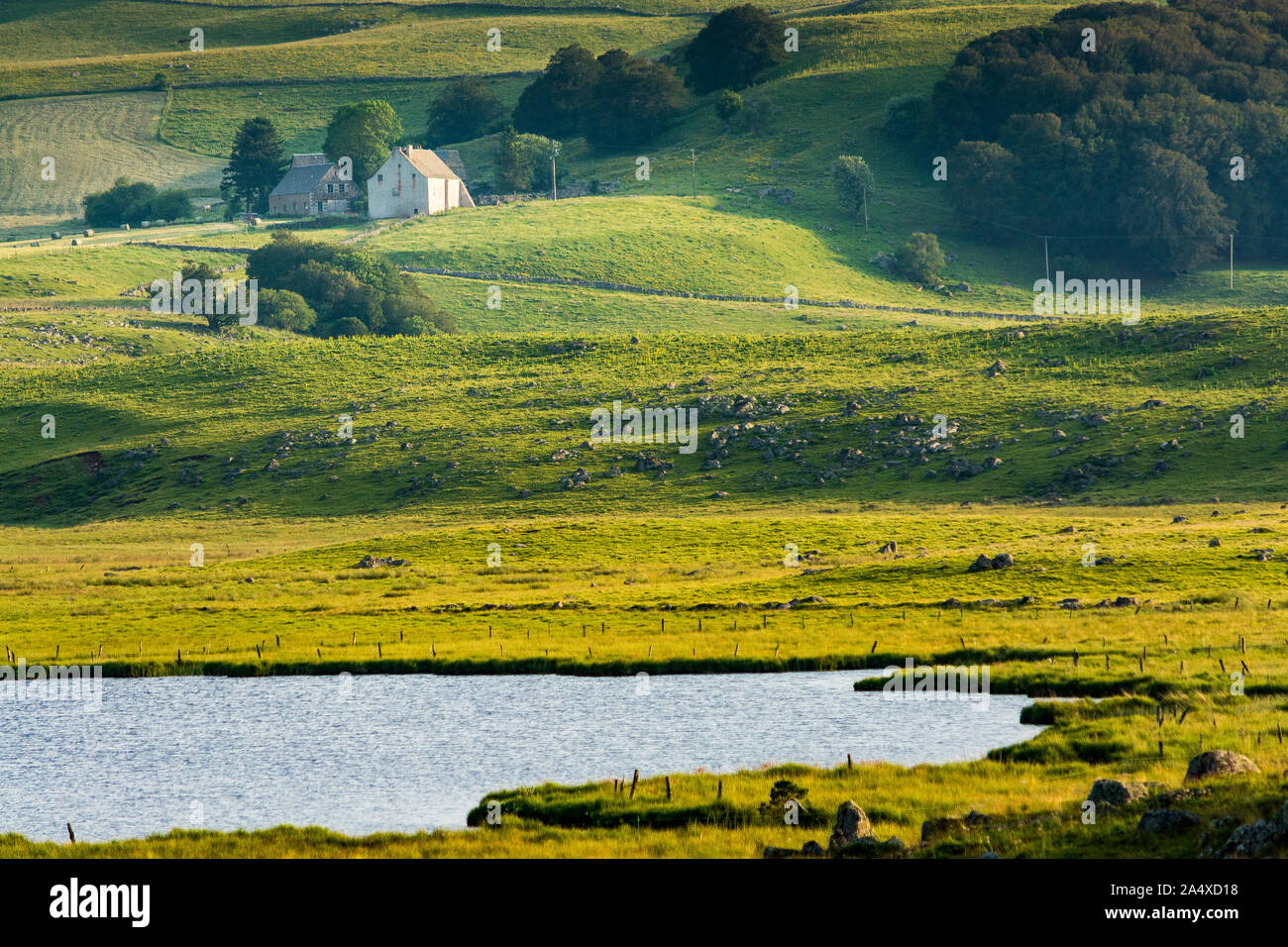 Farm, lake and meadows: a landscape of the Aubrac plateau in France ...