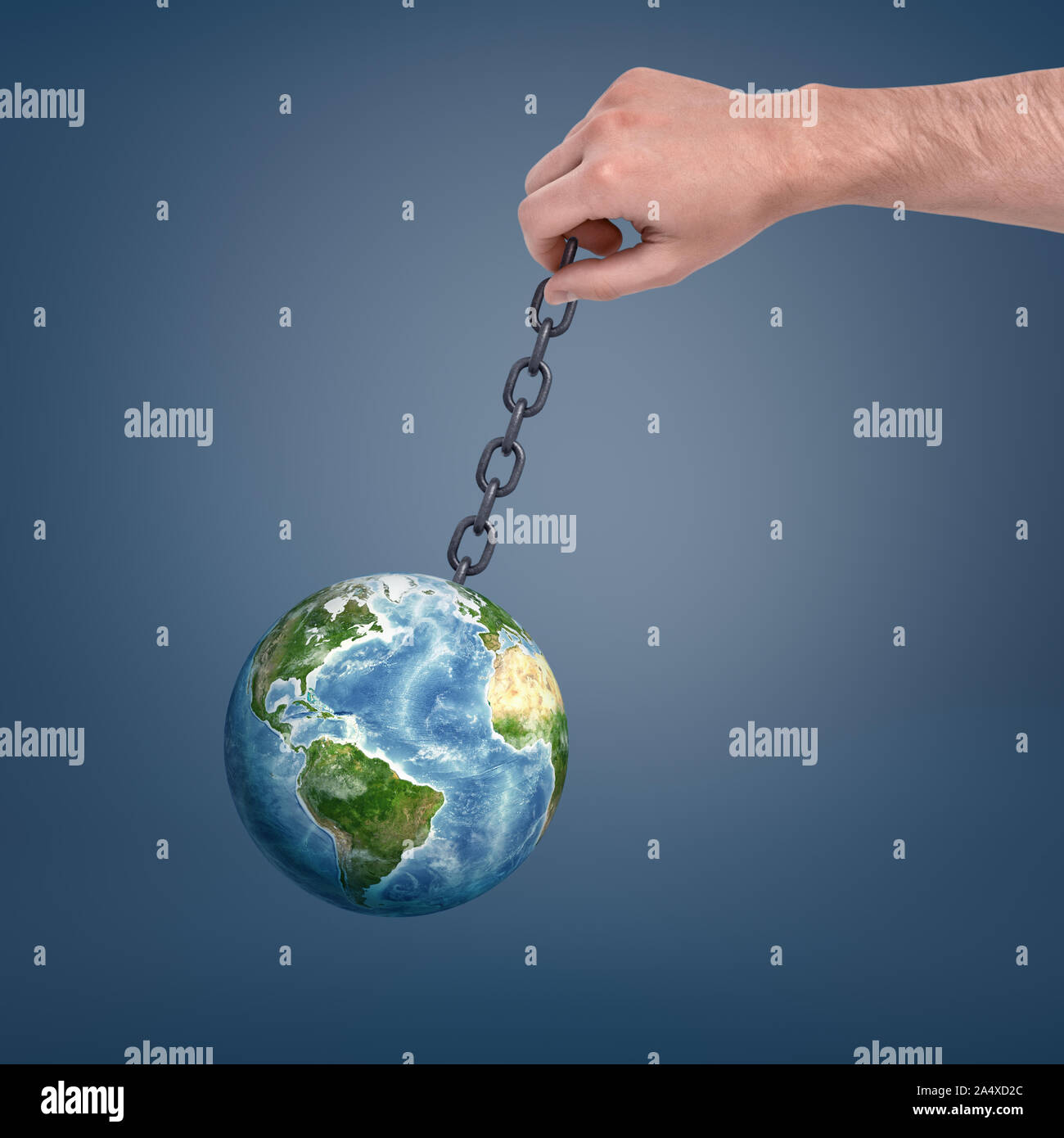 A large male hand holding a metal chain with a Earth globe handing on ...