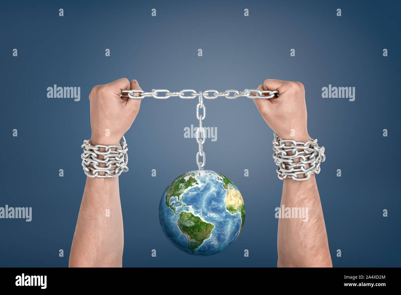 Two male hands bound together with chains and linked to an Earth globe ...