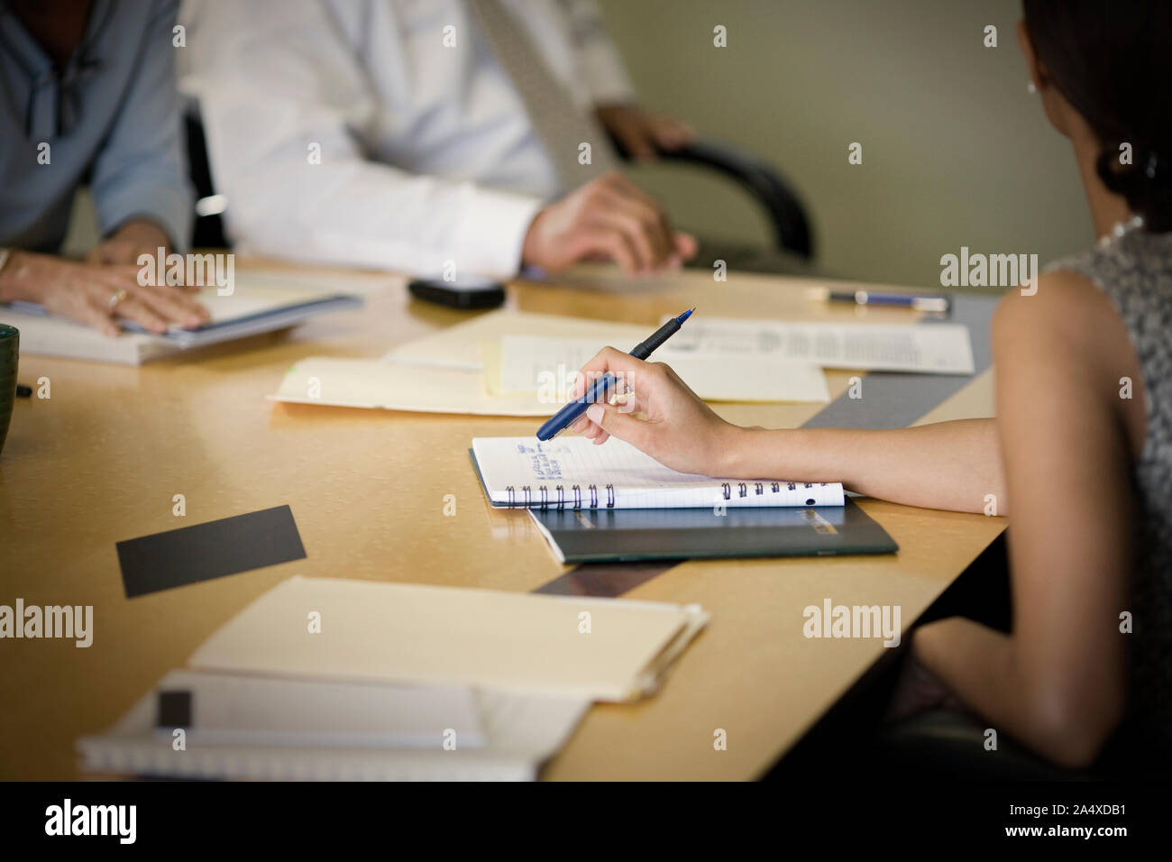 Notes being taken by business people in a boardroom Stock Photo - Alamy