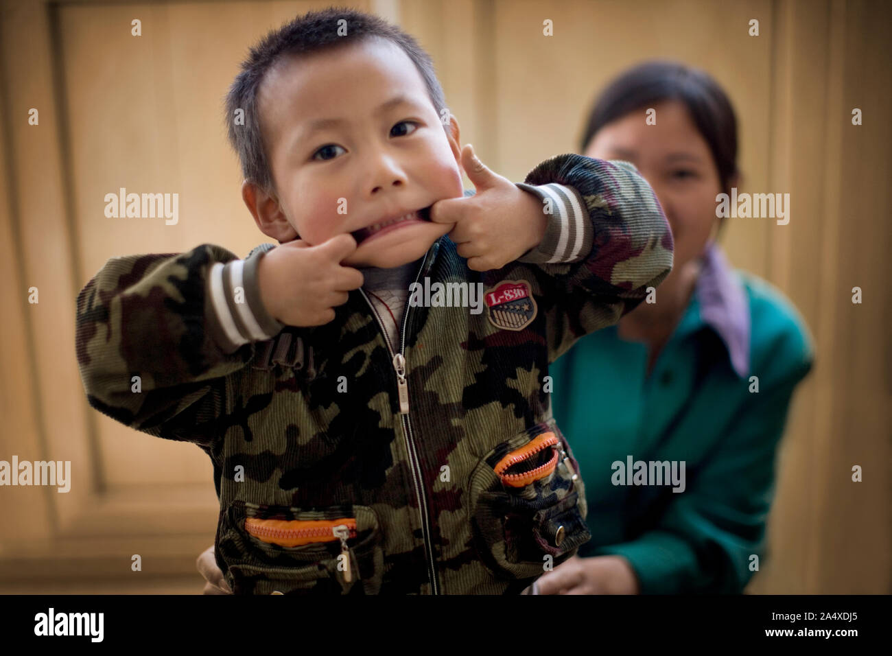 Portrait of a boy pulling a face Stock Photo - Alamy