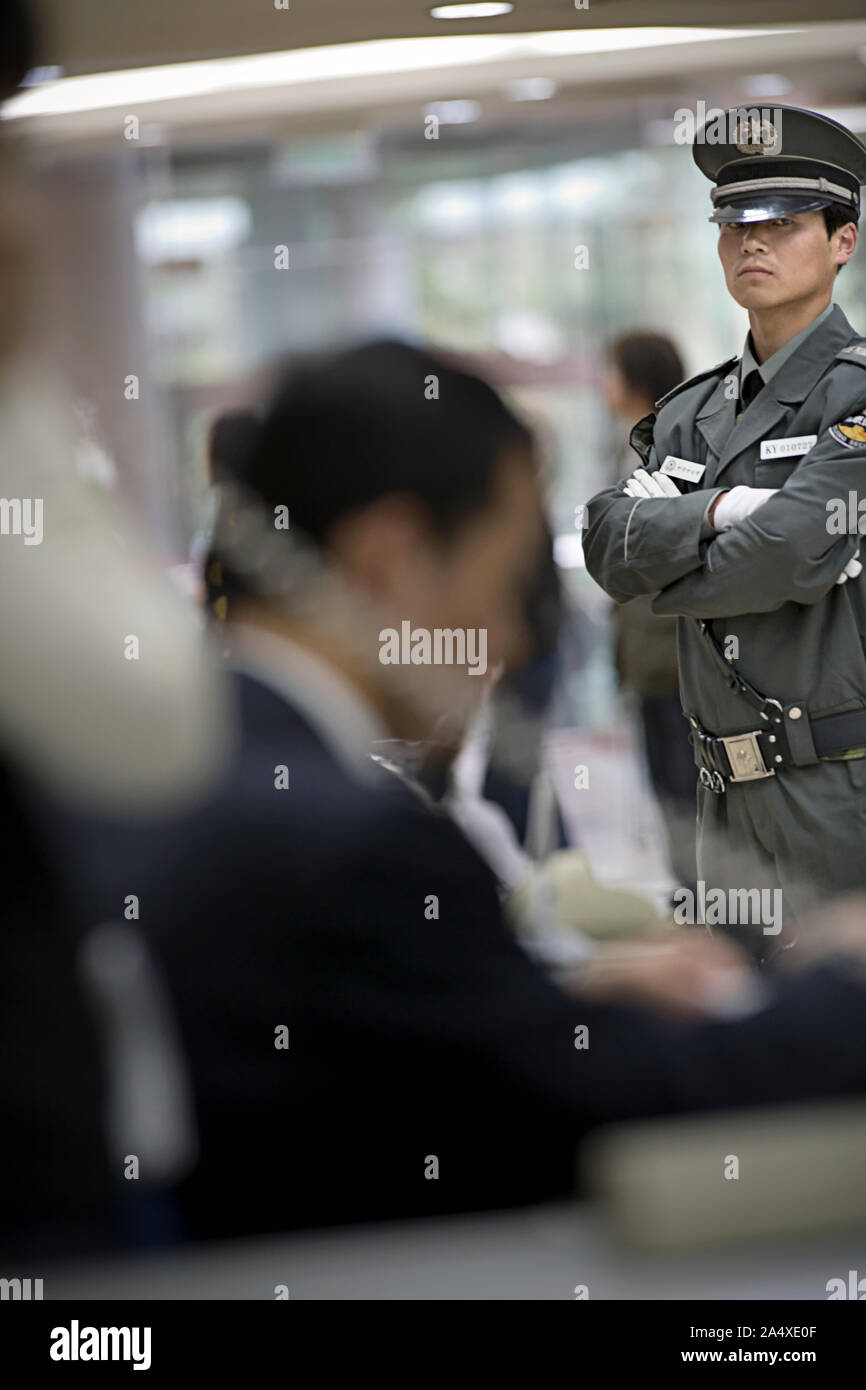 Portrait of a mid-adult male officer with folded arms Stock Photo - Alamy
