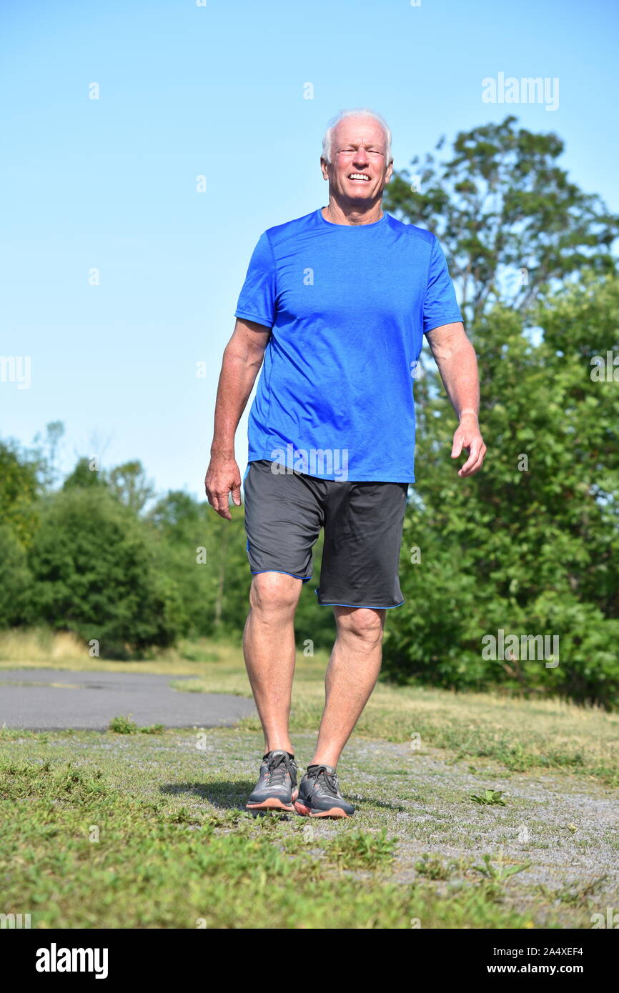 An Old Male Senior Smiling Walking Stock Photo - Alamy