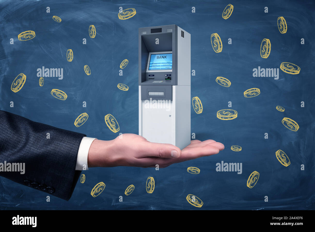 A large businessman's hand holding a small ATM machine on a background ...