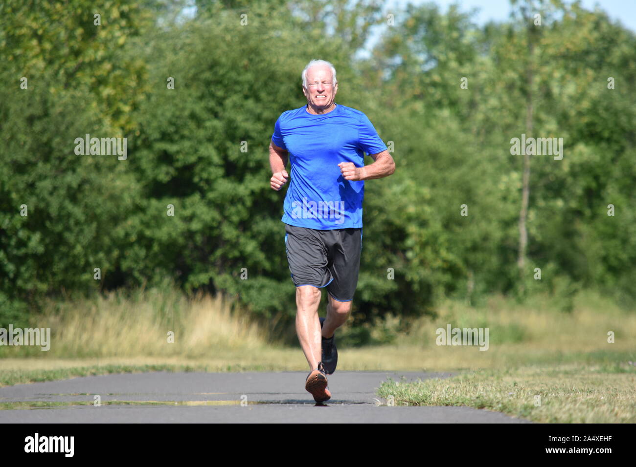 Happy Male Senior Man Running Stock Photo - Alamy