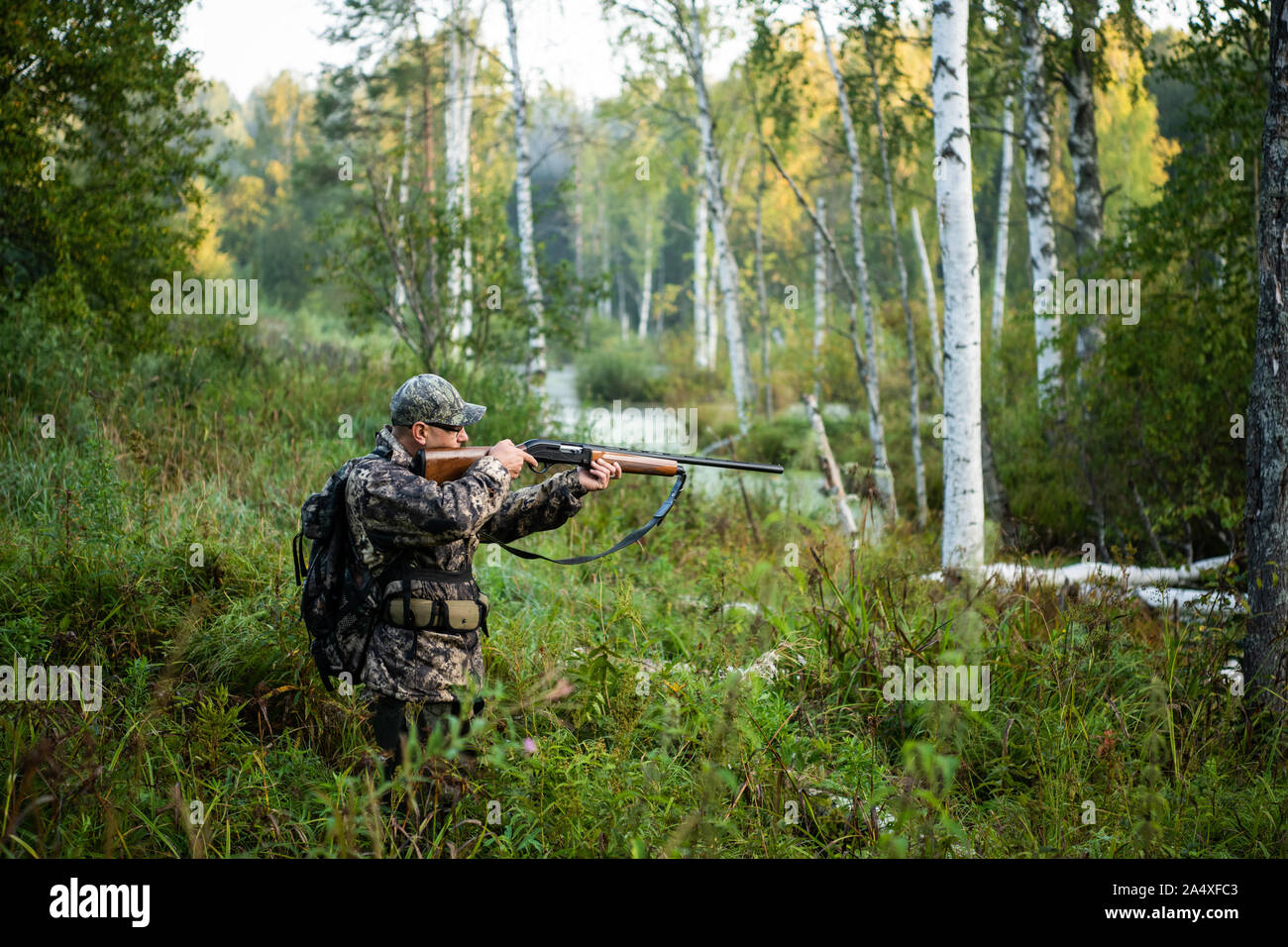Hunter aiming with weapon at the outdoor hunting Stock Photo - Alamy