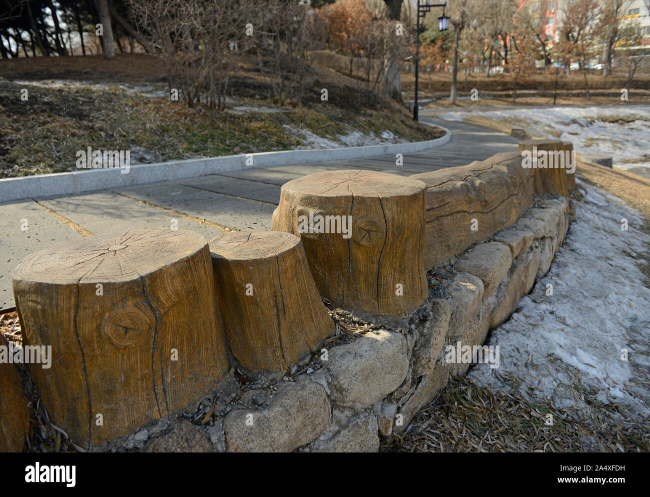 Concrete tree stumps line a path in a park in Changchun, China Stock ...