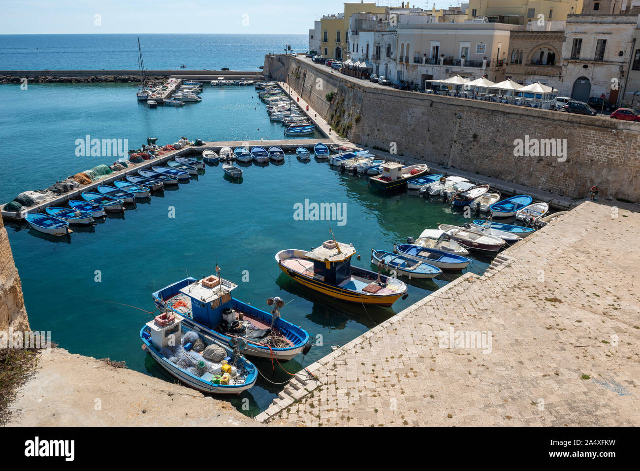 Boats moored in harbour next to old city wall in Gallipoli old town ...